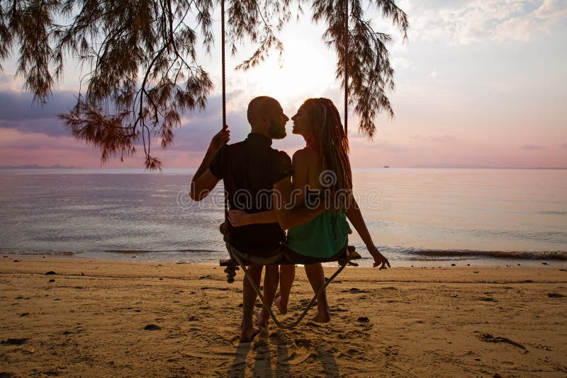 Couple swinging on a swing stock photo. Image of romance - 88815848