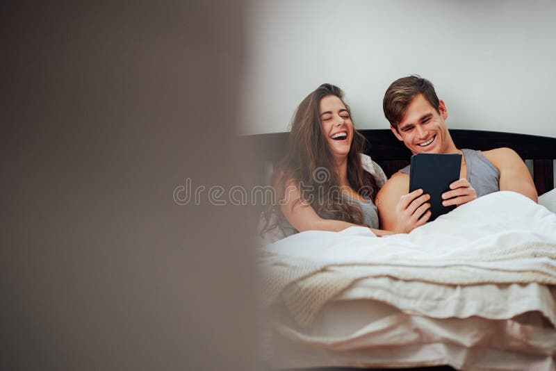 Couple Tablet And Laughing In Bed Home And Relax With Funny Meme