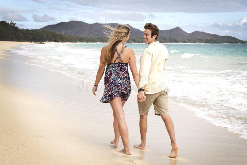 Couple Take a Walk on the Beach Stock Image - Image of natural, clouds ...