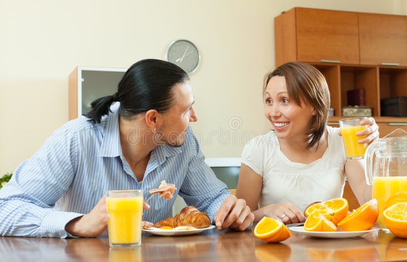 Couple Talking Over Breakfast at Home in Morning Stock Image - Image of ...