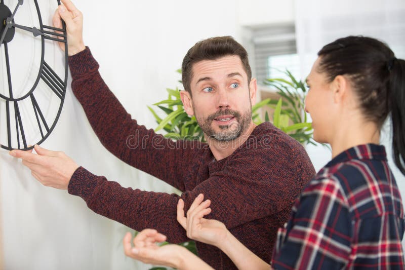 Couple Talking about Place Clock Stock Photo - Image of adult, male ...