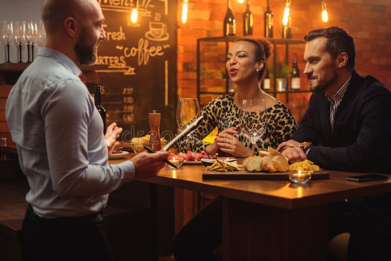 Couple Talking To Bartender Behind Bar Counter in a Cafe Stock Image - Image of date, girl ...