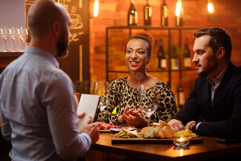 Couple Talking To Bartender Behind Bar Counter in a Cafe Stock Image ...