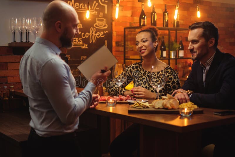 Couple Talking To Bartender Behind Bar Counter in a Cafe Stock Image ...