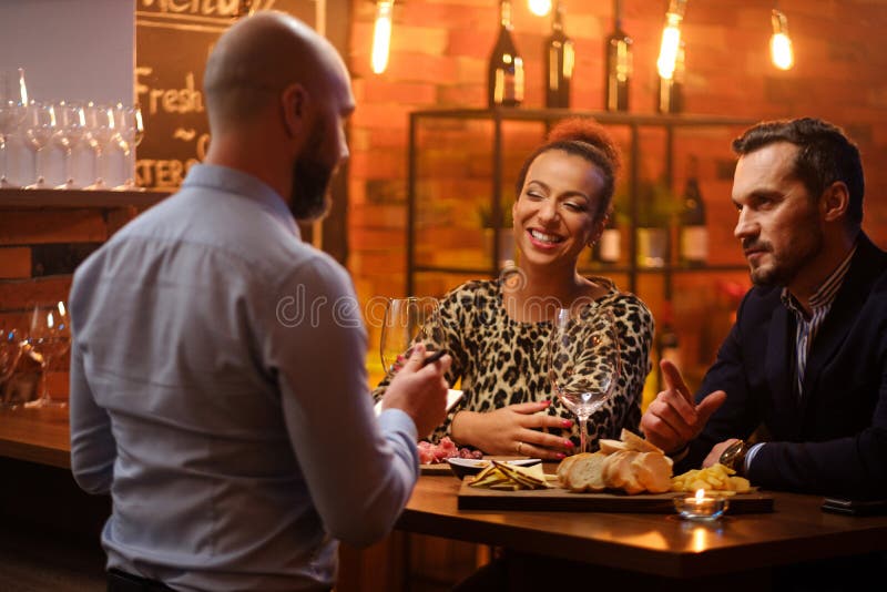 Couple Talking To Bartender Behind Bar Counter in a Cafe Stock Image ...