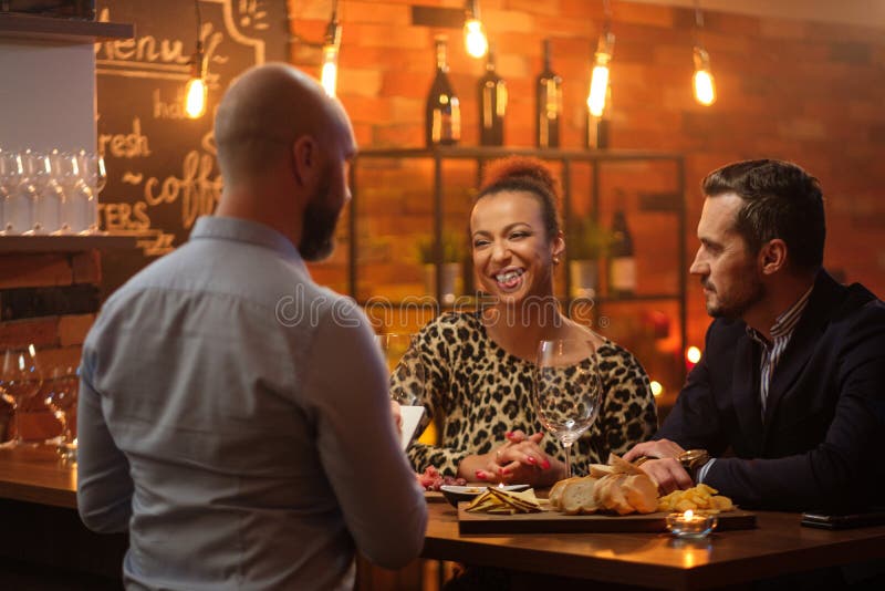 Couple Talking To Bartender Behind Bar Counter in a Cafe Stock Image ...