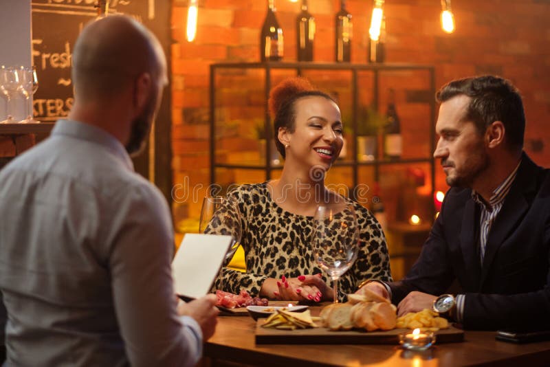 Couple Talking To Bartender Behind Bar Counter in a Cafe Stock Image ...
