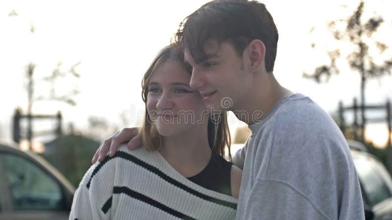 Couple Of Teenagers In Love The Guy Put His Hand On The Shoulder Of