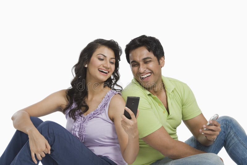 Couple Text Messaging on Mobile Phones Stock Photo - Image of ...