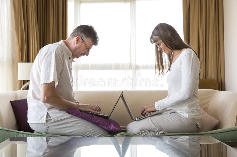 Couple in their computers stock photo. Image of laptop - 93821642