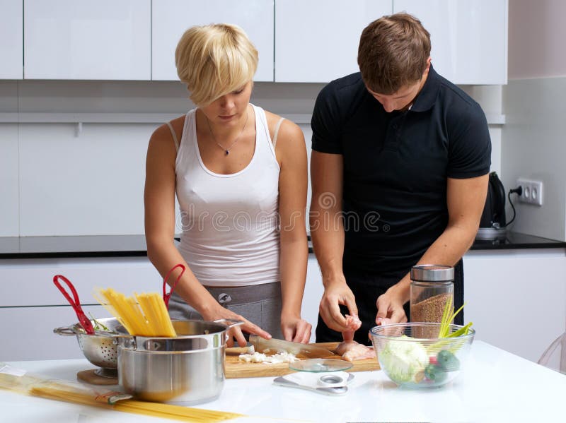 Couple in Their Kitchen Making Dinner Stock Photo - Image of male ...