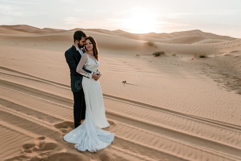A Couple in Their Wedding Dresses in the Desert Stock Photo - Image of ...