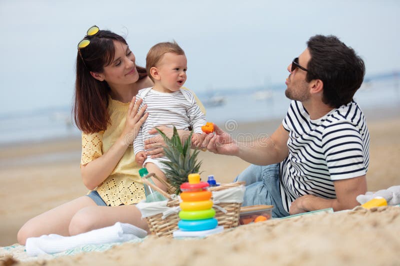 Couple with Three Months Old Baby on Beach Stock Photo - Image of human ...