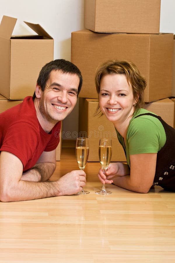 Couple Toasting in Their New Home Stock Photo - Image of flat, home ...