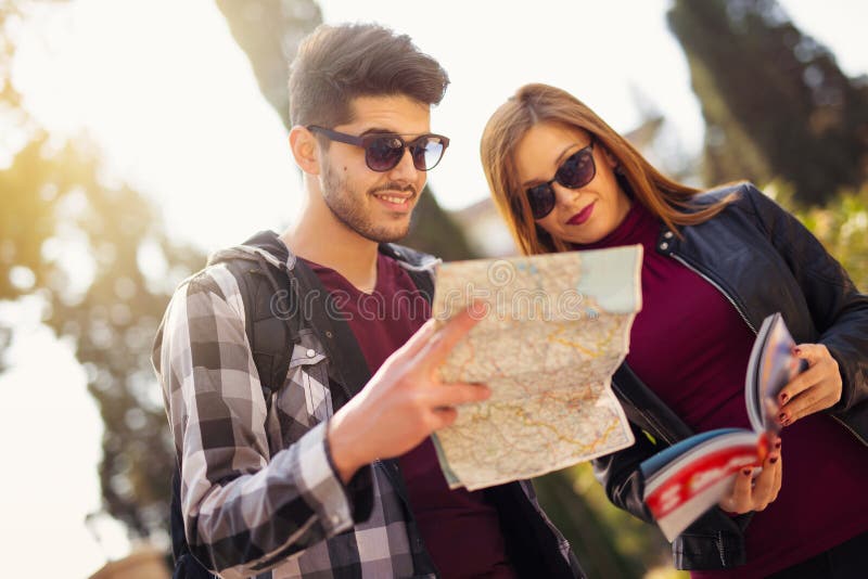 Couple of Tourists Looking at Traveler S Guide and a Map Stock Image ...