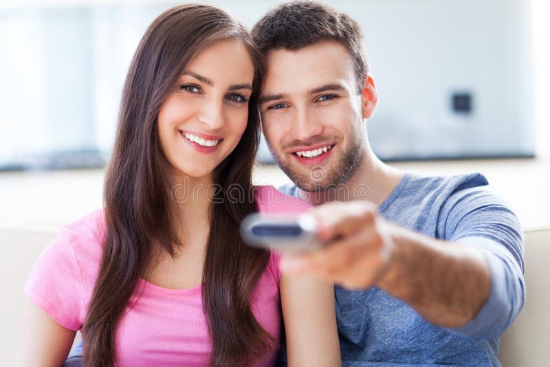 Couple with TV remote stock photo. Image of smile, young - 30630314