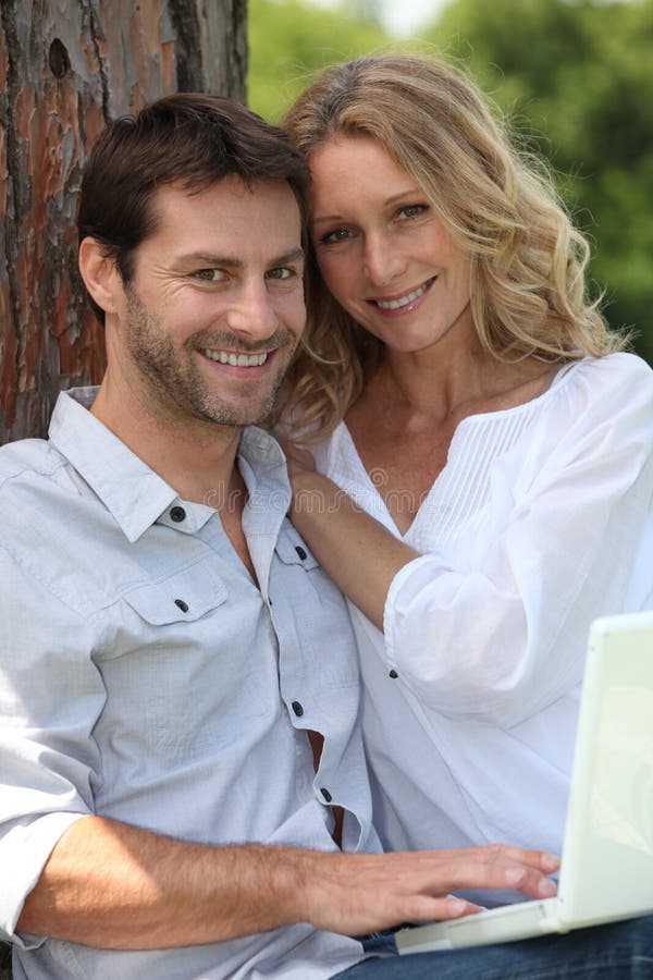 Couple under a tree stock photo. Image of caucasian, grass - 22919570