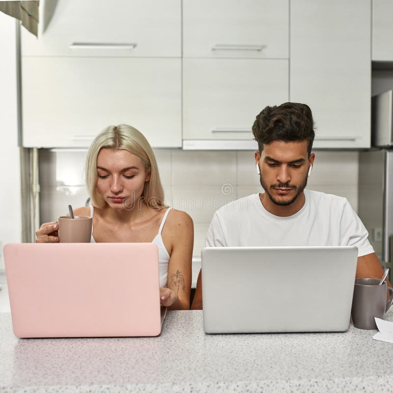 Couple Use and Work on Laptops at Table at Home Stock Image - Image of ...