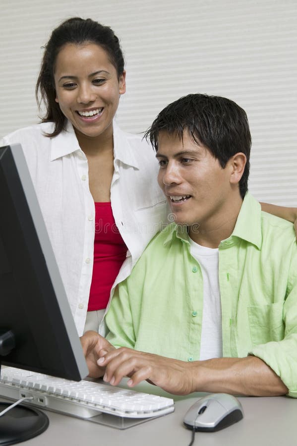 Couple Using Computer at Desk Stock Image - Image of computer, short ...