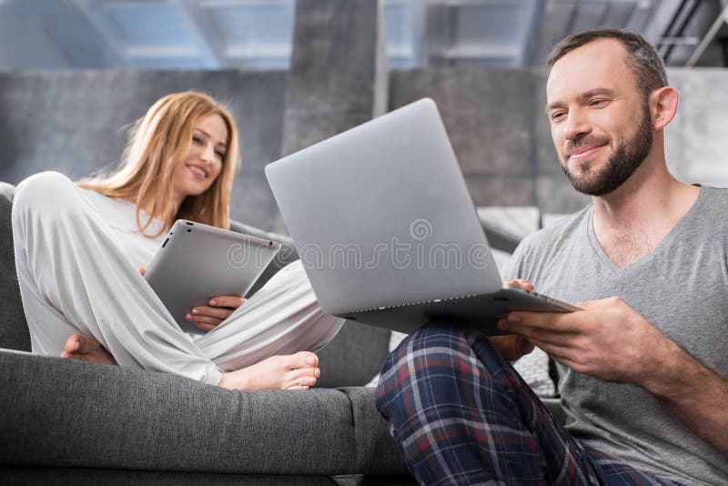 Couple Using Digital Devices Stock Image - Image of female, couple ...