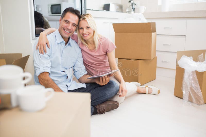 Couple Sitting on Floor by Open Boxes in New Home Stock Image - Image ...