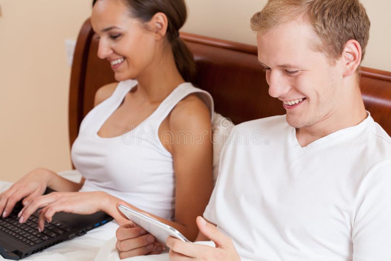 Couple Using Internet in Bed Stock Image - Image of husband, relaxation ...