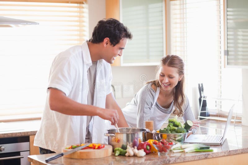 Couple Using the Internet To Look Up Recipe Stock Photo - Image of ...