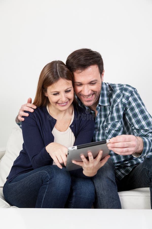 Couple using the ipad stock image. Image of attractive - 62740693