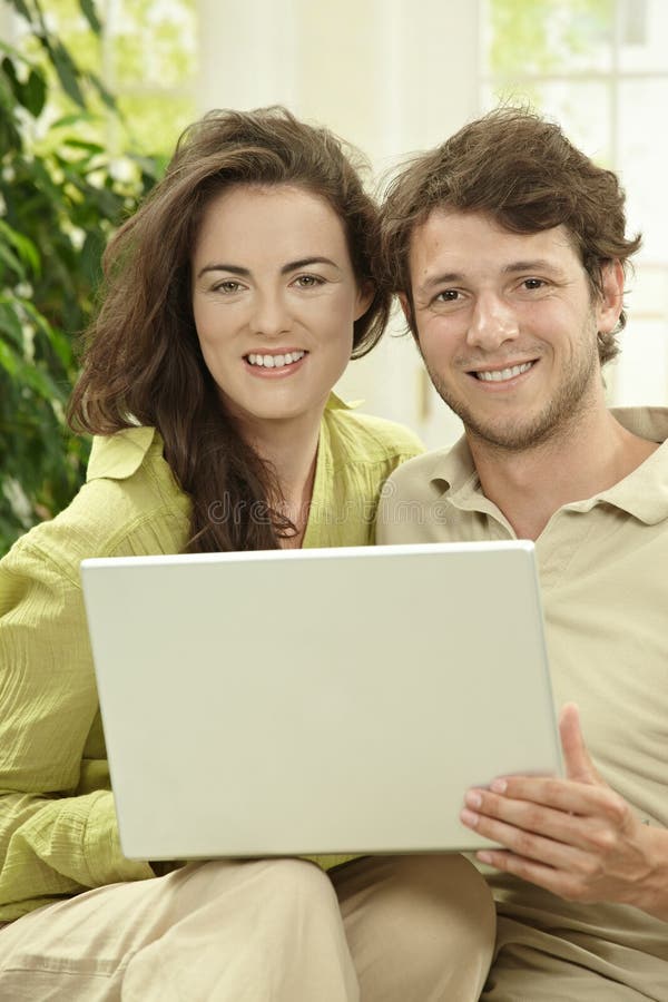 Couple using laptop stock image. Image of jeans, house - 10993105