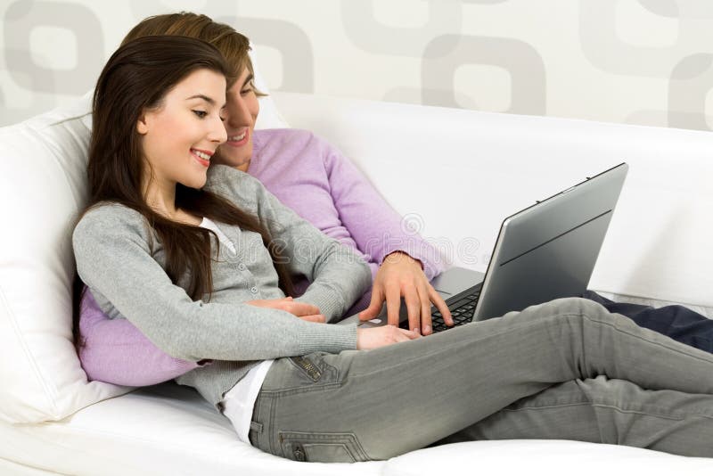 Young couple with laptop stock image. Image of admiration - 1616141