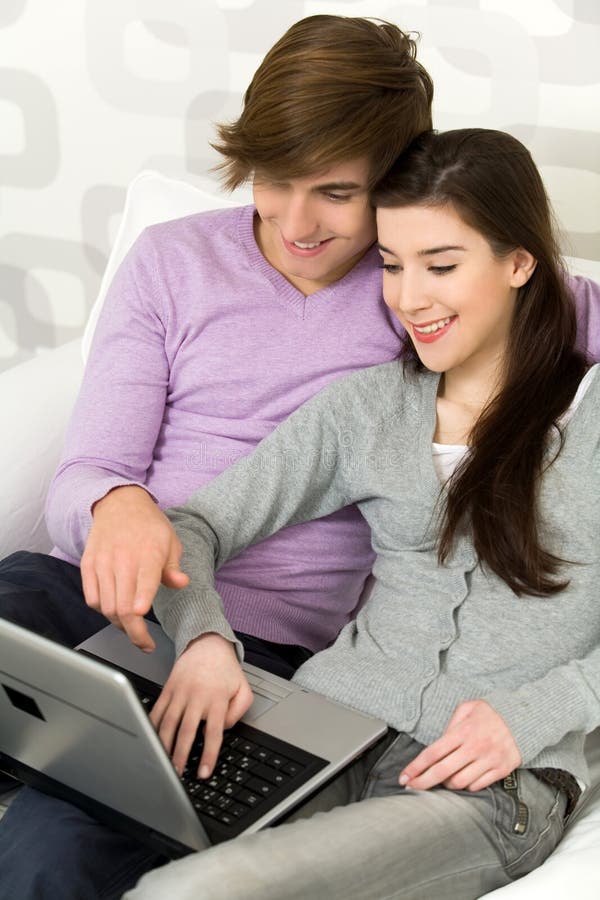 Couple using laptop stock image. Image of smiling, couch - 12874469