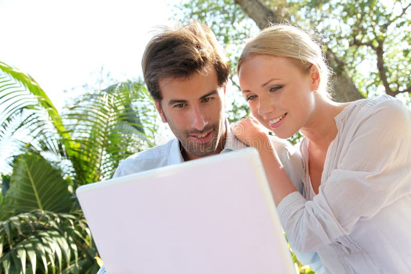 Couple Using Laptop Computer Stock Image - Image of smiling, computer ...