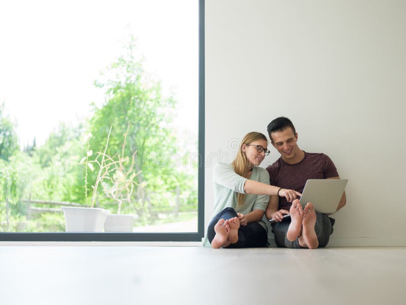 Couple Using Laptop on the Floor at Home Stock Photo - Image of face ...