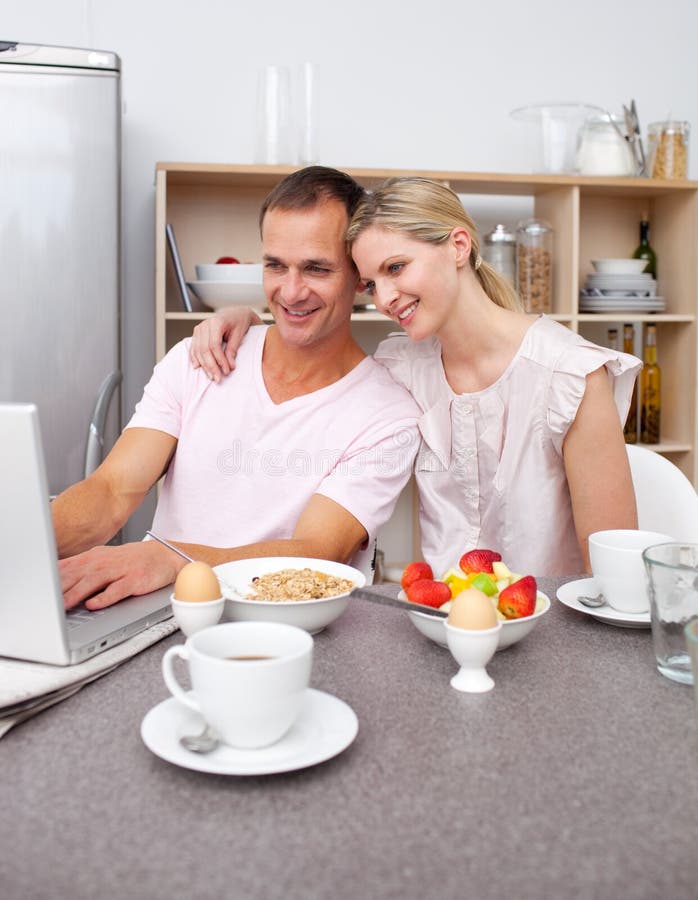 Couple Using a Laptop while Having Breakfast Stock Photo - Image of ...