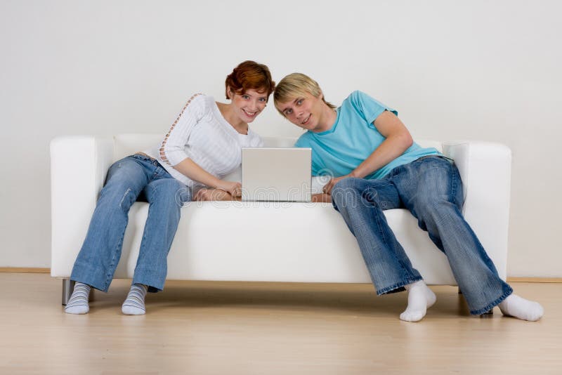 Couple Using Laptop on Sofa Stock Image - Image of friends, cheerful ...
