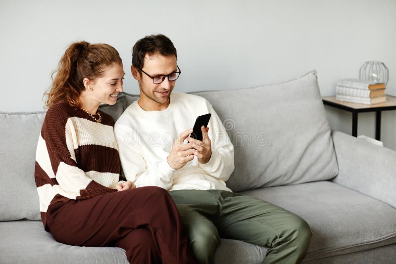 Couple Using Mobile Phone at Home Stock Image - Image of enjoyment ...
