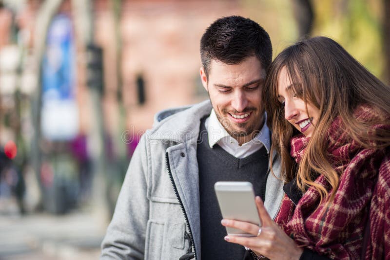 Couple Using Phone in Street Stock Image - Image of stylish, street ...