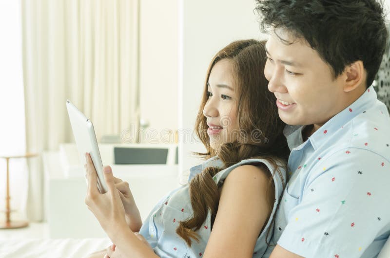 Couple Using Tablet on the Bed Stock Photo - Image of digital ...