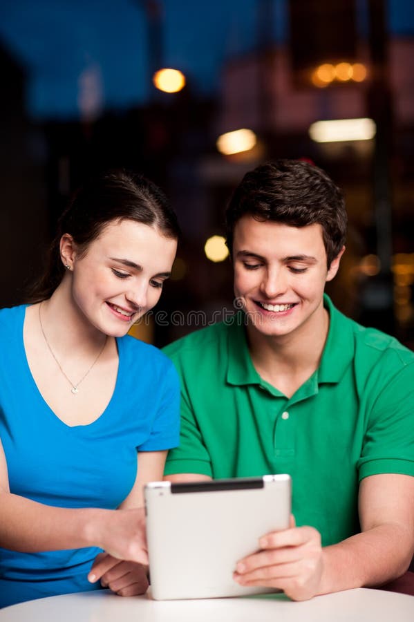 Couple Using Tablet Computer at an Outdoor Cafe Stock Photo - Image of ...