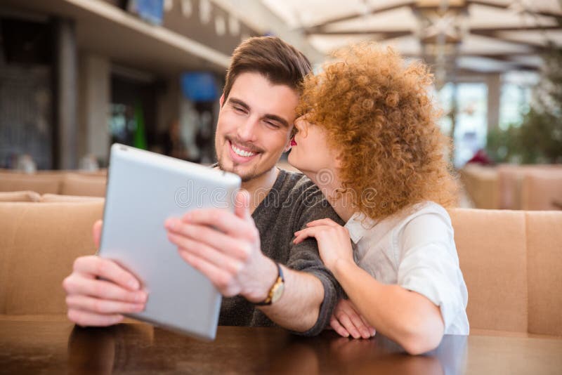 Couple Using Tablet Computer in Restaurant Stock Photo - Image of chat ...