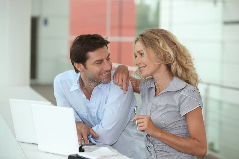 Couple using two laptops stock image. Image of landscape - 24619877