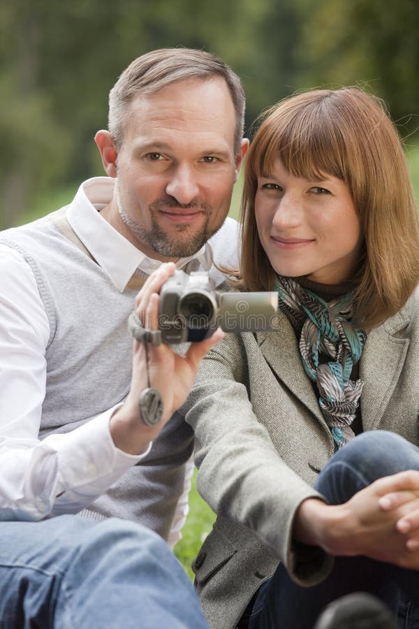 Couple with video camera stock photo. Image of friends - 10915454