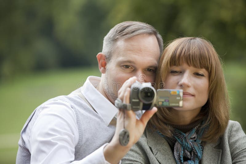 Couple with video camera. stock image. Image of outdoors - 2431845