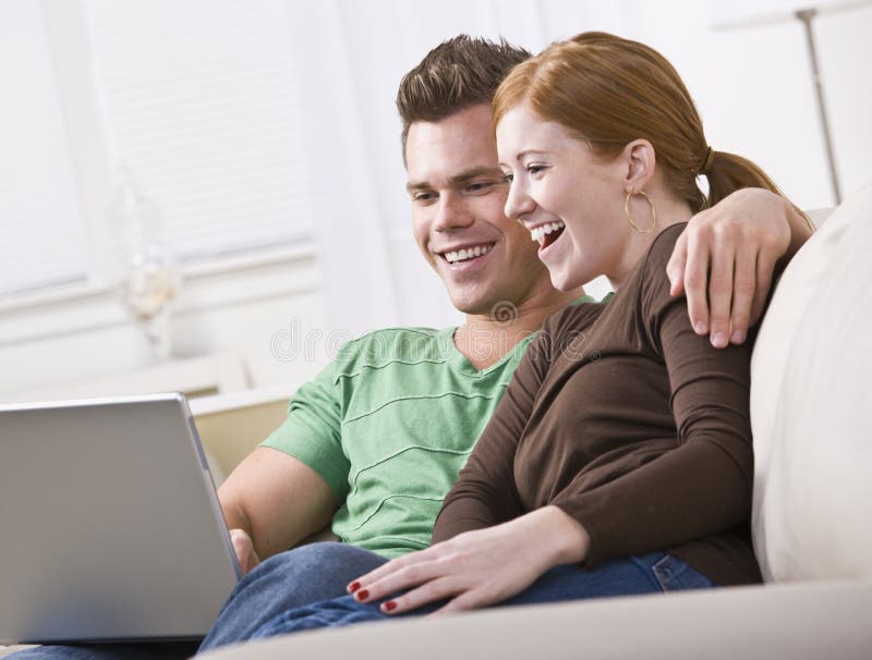 Couple Viewing Laptop stock photo. Image of house, laptop - 9913400
