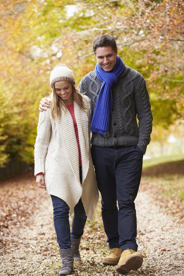 Couple Walking Along Autumn Path Stock Image - Image of happy, forties ...