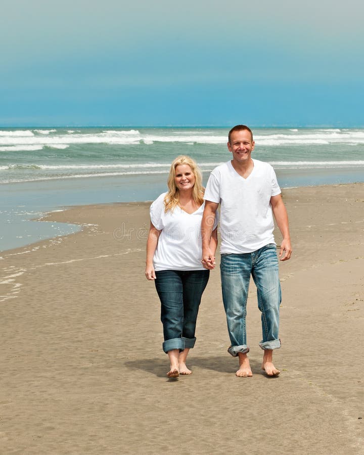 Couple Walking on the Beach Stock Photo - Image of female, arms: 5046456