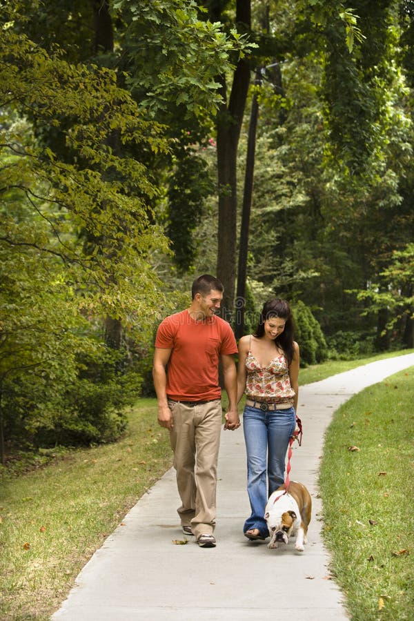 Couple walking dog. stock photo. Image of lifestyle, couple - 3423854