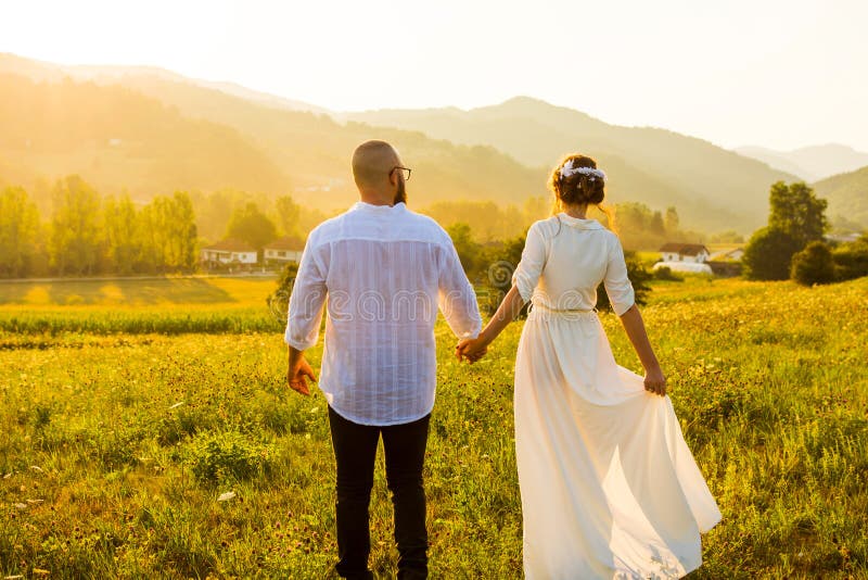 Couple Walking on the Field with Sunset View Stock Image - Image of ...