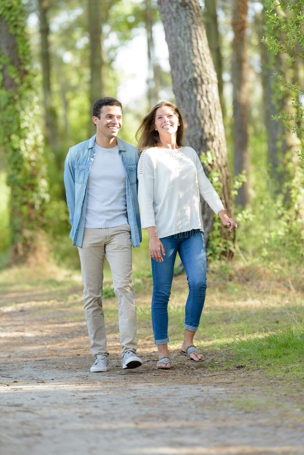 Couple walking in forest stock image. Image of summer - 171370769