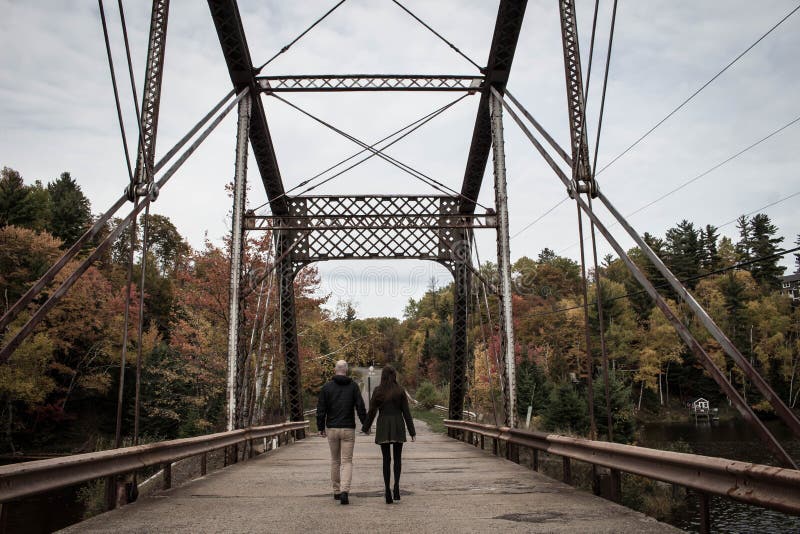 Couple Walking on Gray Bridge at Daytime Stock Photo - Image of love ...